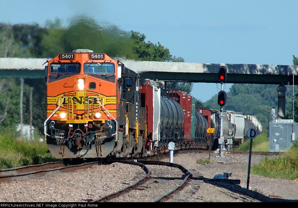 BNSF 5401 and and two NS units are westbound crossing the UP's Falls City sub